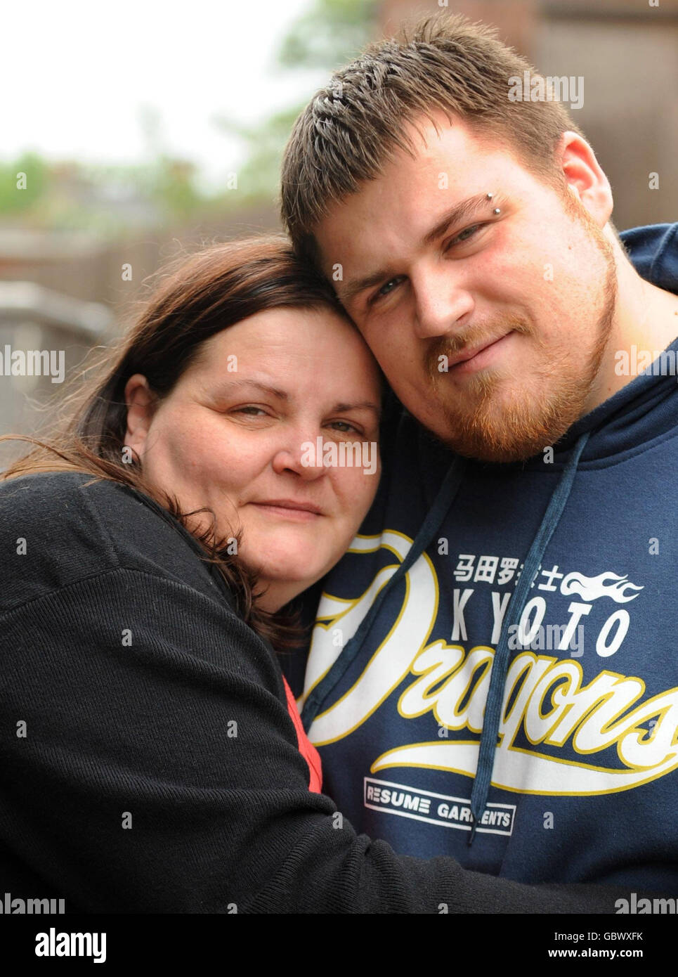 Receives a hug from her elder son hi-res stock photography and images ...