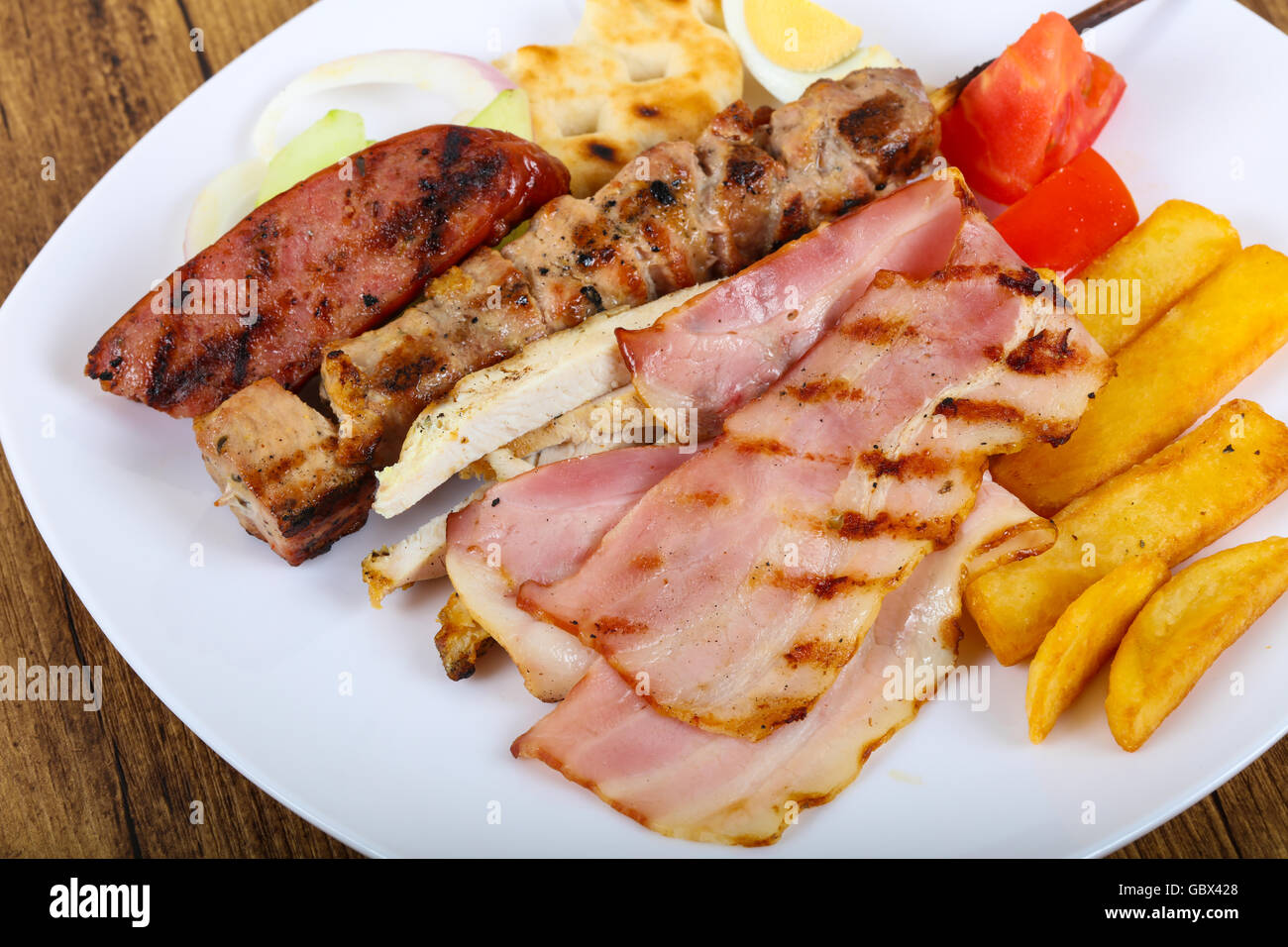 Grill meat mix with potato and tomato Stock Photo - Alamy