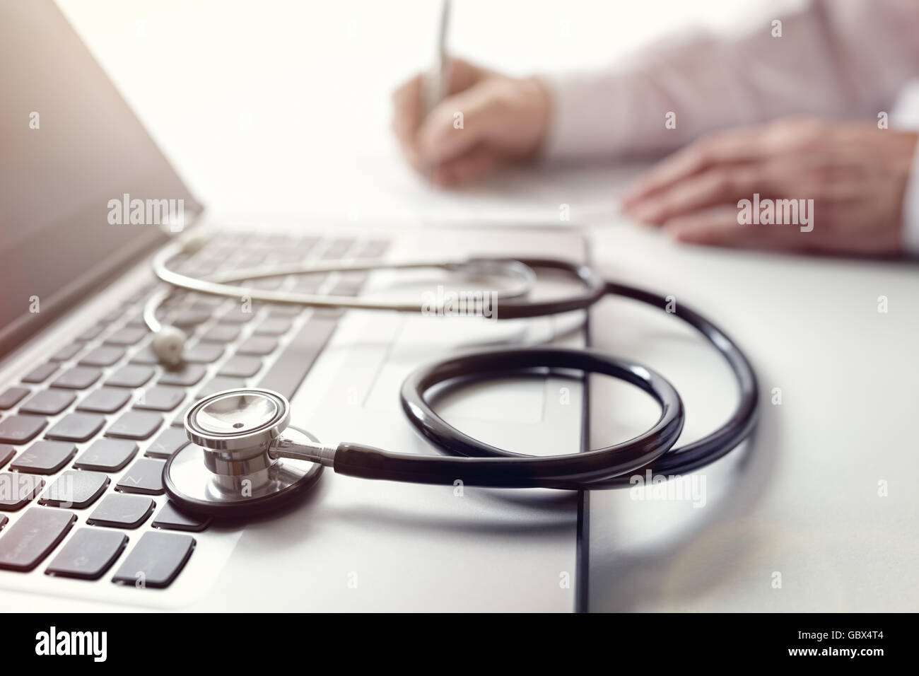 Doctor writing patient notes on a medical examination or prescription ...