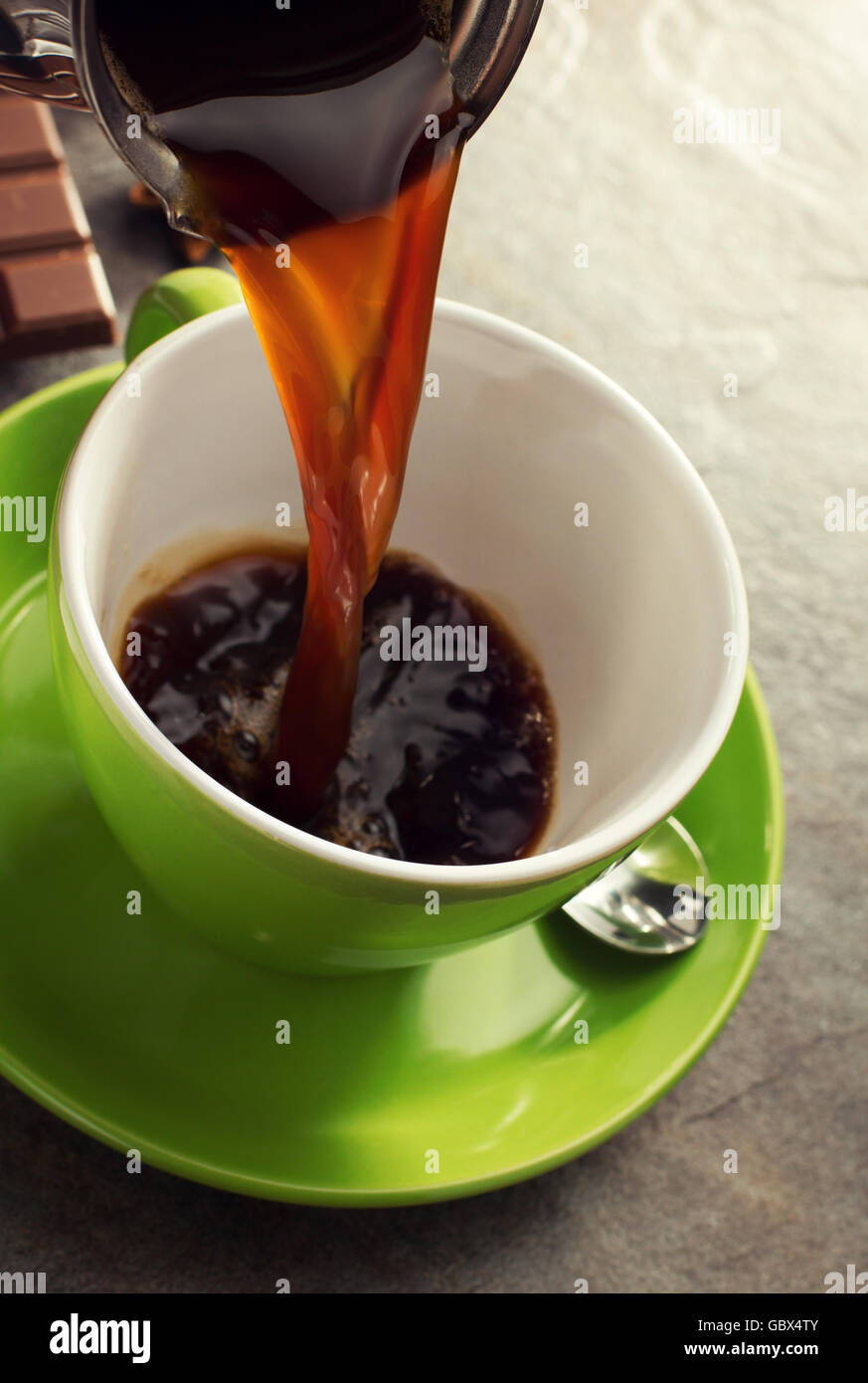 pouring coffee in cup on table Stock Photo - Alamy