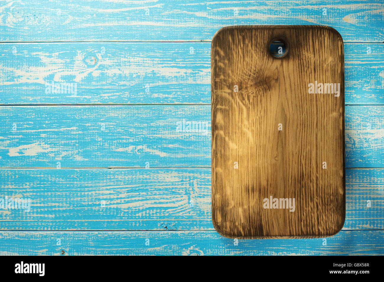 cutting board at wooden table Stock Photo - Alamy