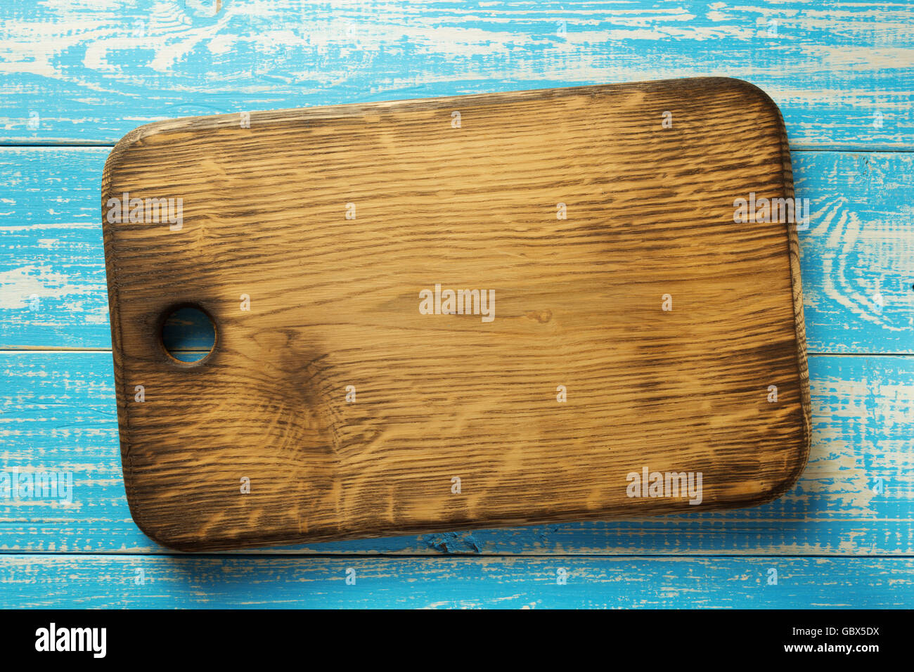 cutting board at wooden table Stock Photo - Alamy