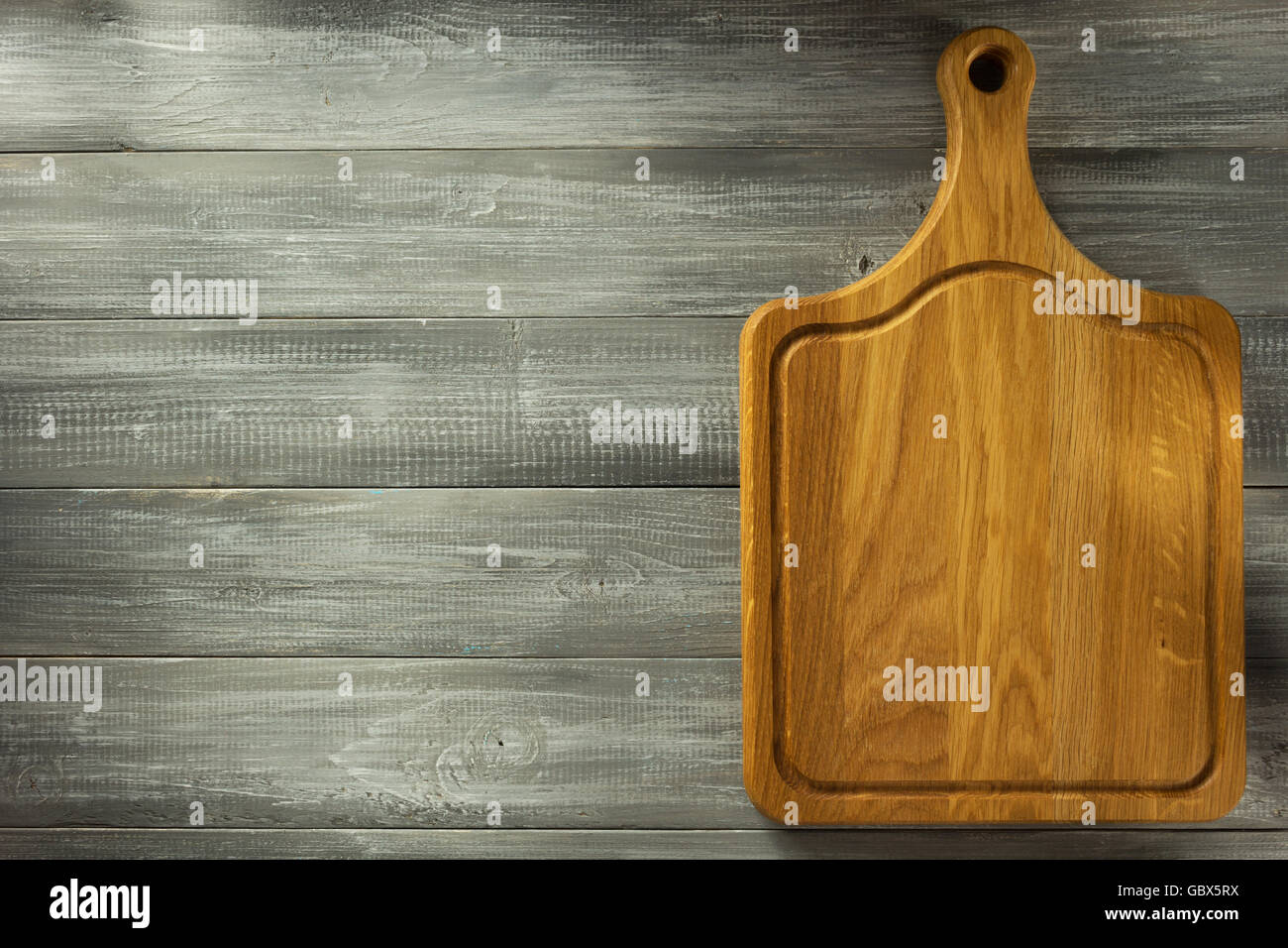 cutting board at wooden table surface Stock Photo - Alamy