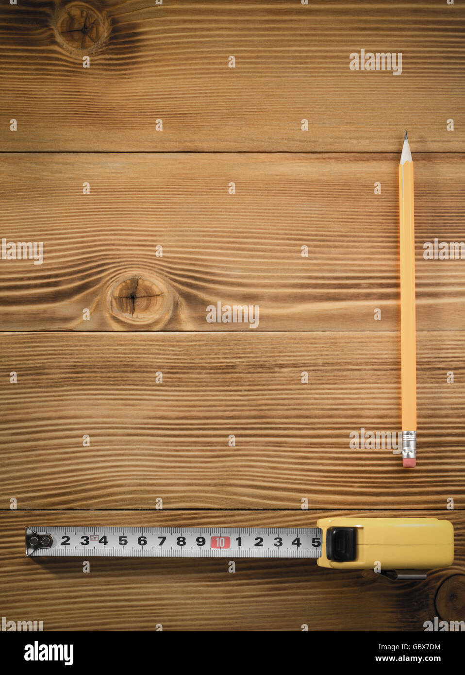tape measure and pencil on wooden texture Stock Photo - Alamy