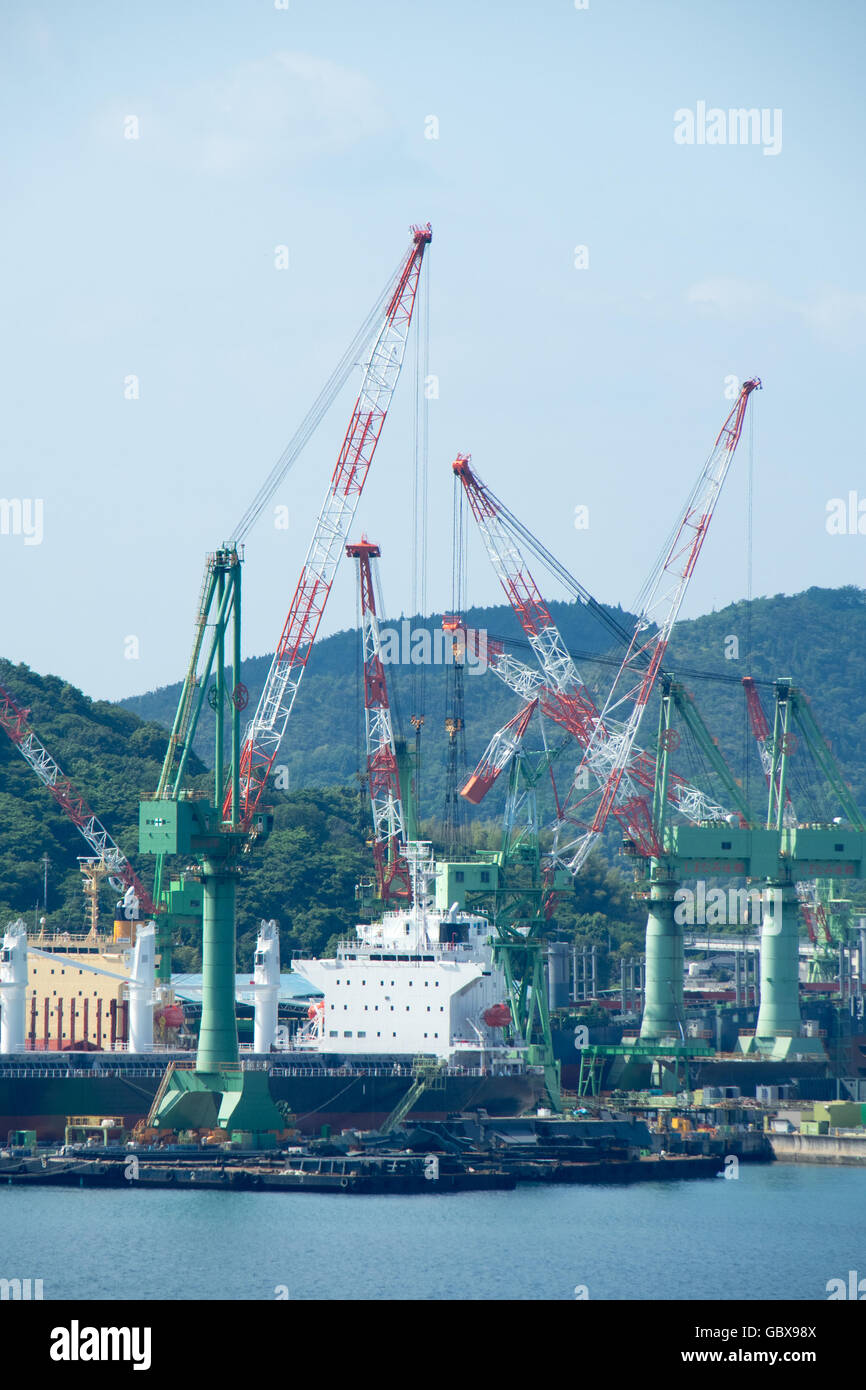 Cranes and a ship being built in a shipyard in japan Stock Photo - Alamy