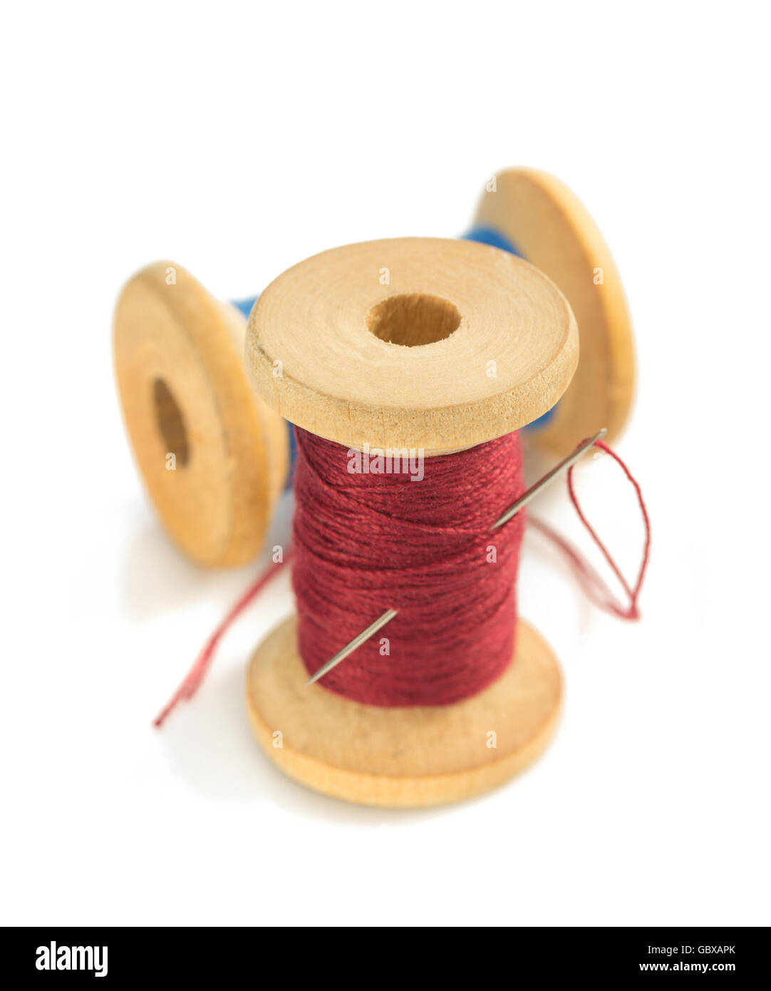 spool of thread and needle isolated on white background Stock Photo - Alamy