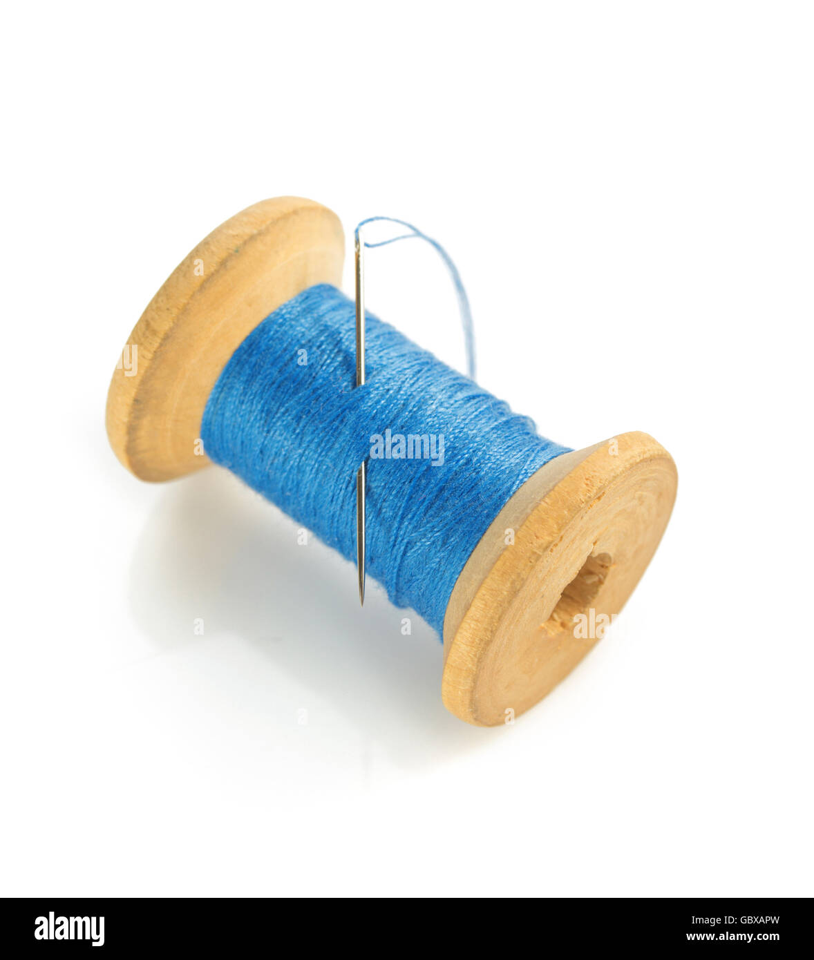 spool of thread and needle isolated on white background Stock Photo - Alamy