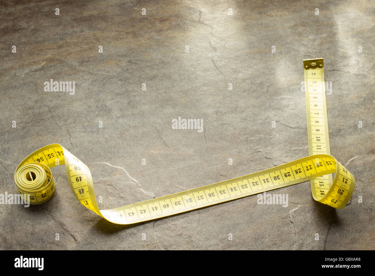 measuring tape on table background Stock Photo - Alamy