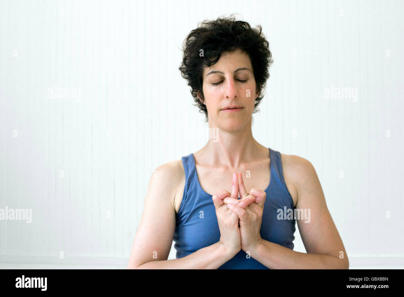 Woman doing yoga in a studio. Pose: "Devi mudra Stock Photo - Alamy