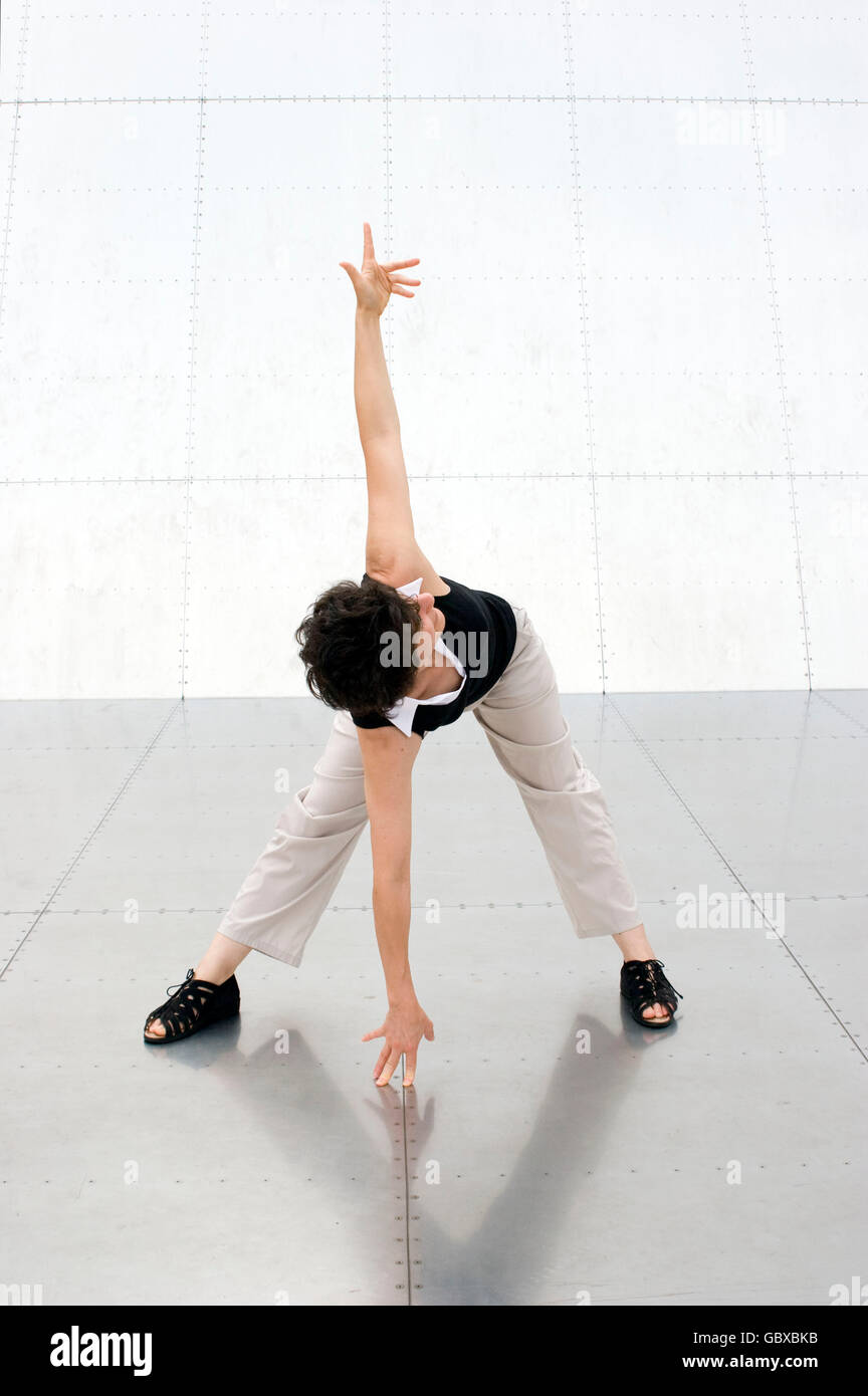 Woman doing yoga (pose: Pyramid Twist Stock Photo - Alamy