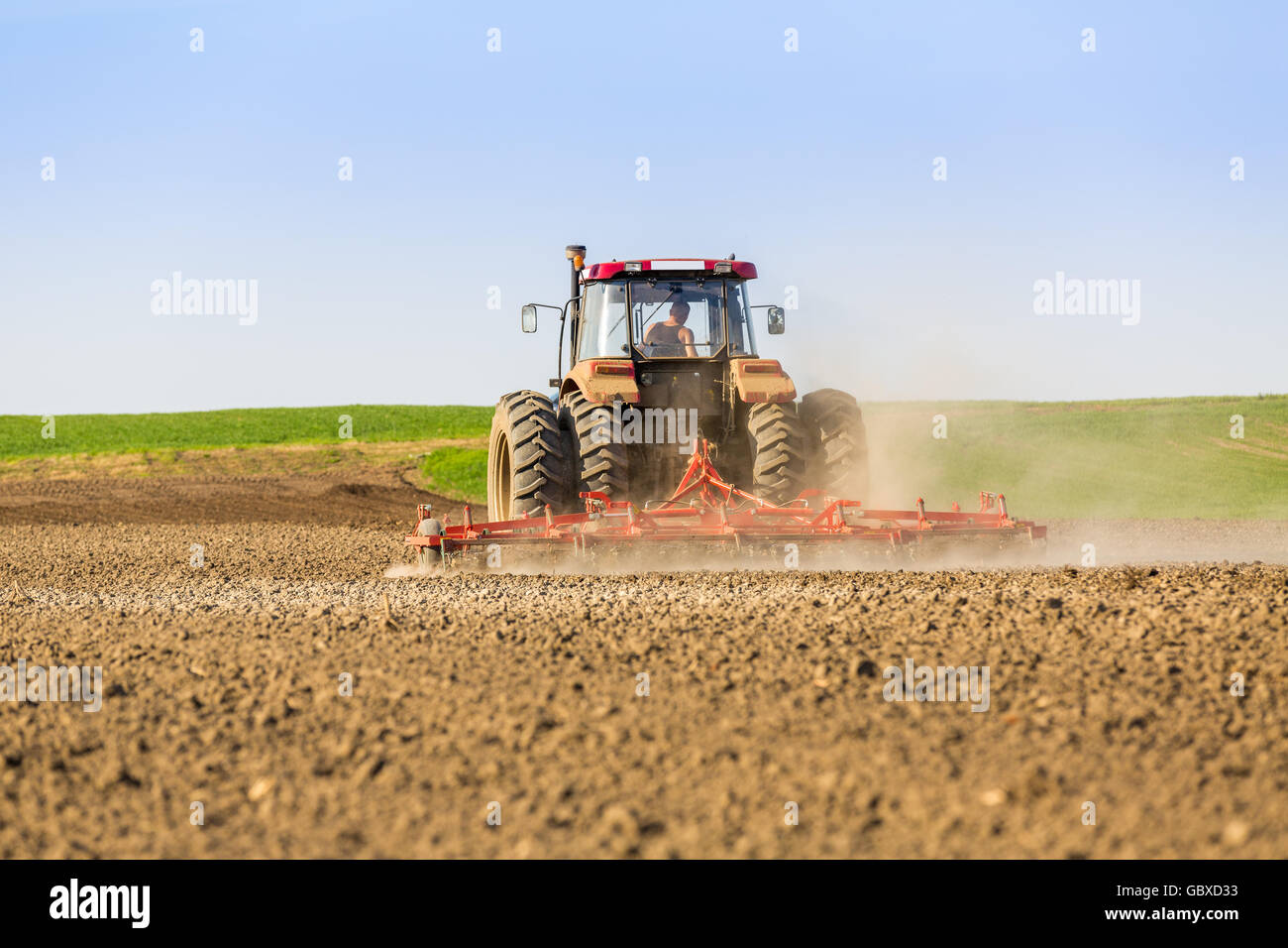 Farmer in tractor preparing land with seedbed cultivator Stock Photo ...