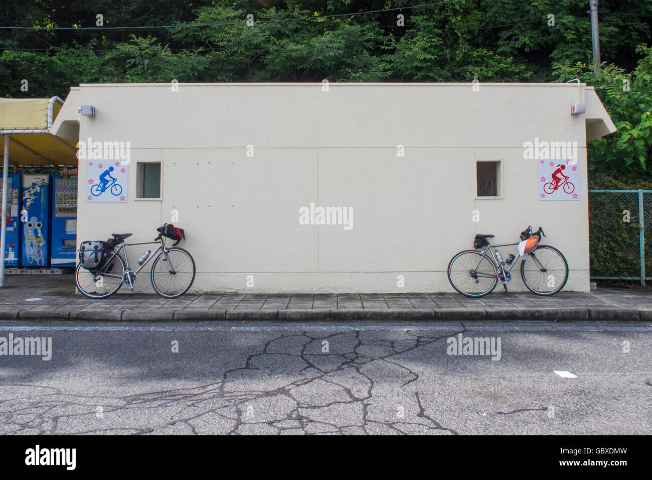 Two road bicycles parked outside public toilets Stock Photo - Alamy