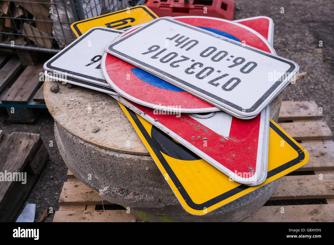 Several traffic signs on a stone at a roadwork Stock Photo - Alamy