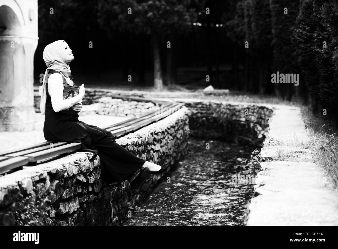 Humble Muslim Woman Is Reading The Koran Outdoors Stock Photo - Alamy