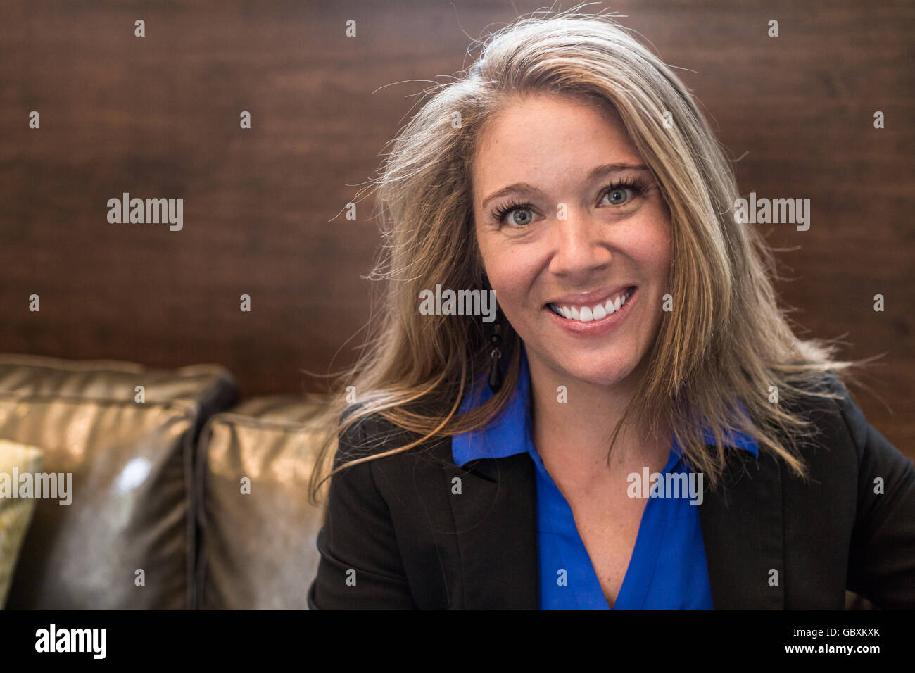 Portrait of business woman in blue shirt Stock Photo - Alamy