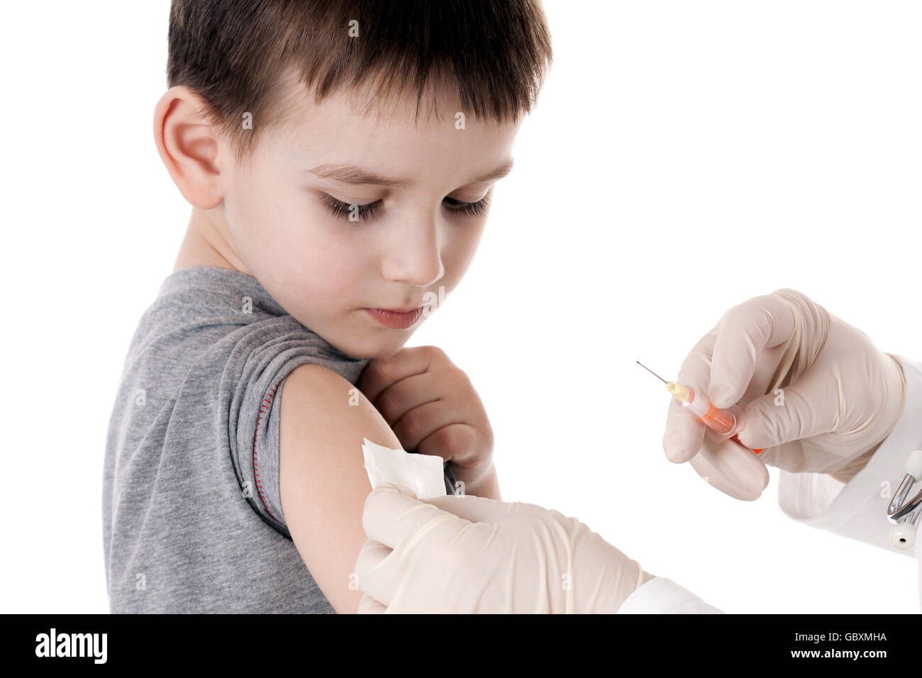 Doctor giving a child injection in arm on isolated image Stock Photo ...