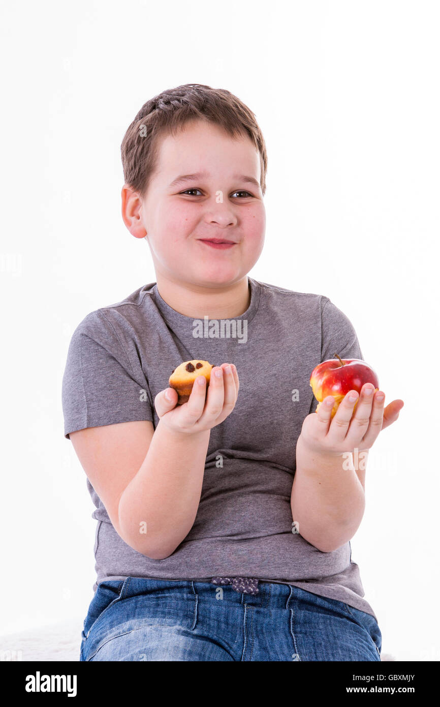 little boy with food isolated on white background - apple or a muffin ...
