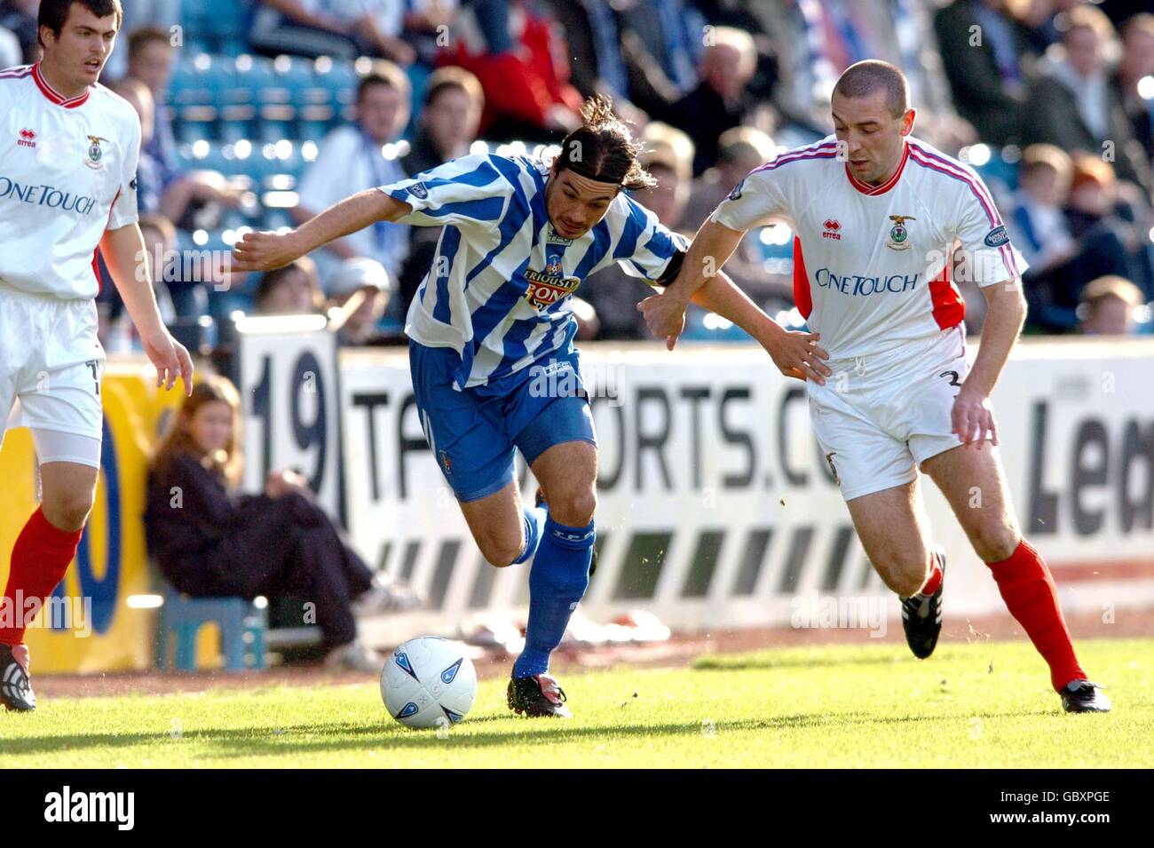Kilmarnock's Danny Invincible battles for possession of the ball with ...
