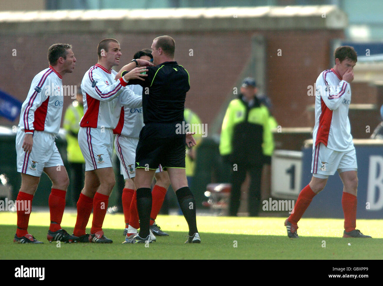 Inverness Caledonian Thistle's Stuart McCaffrrey (r) walks off dejected ...