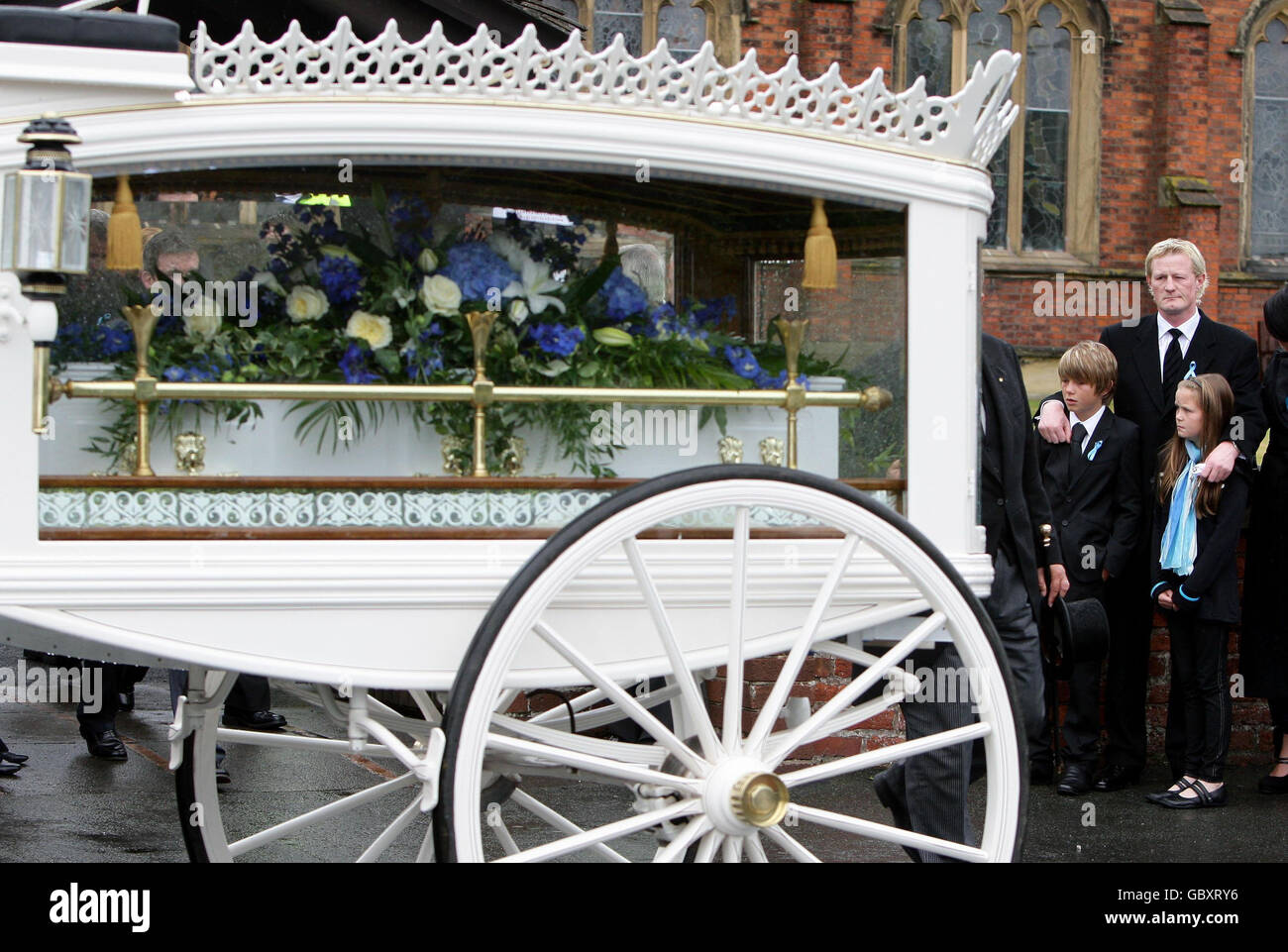 Colin Hendry with children Callum and Niamh, watch the coffin of Denise ...