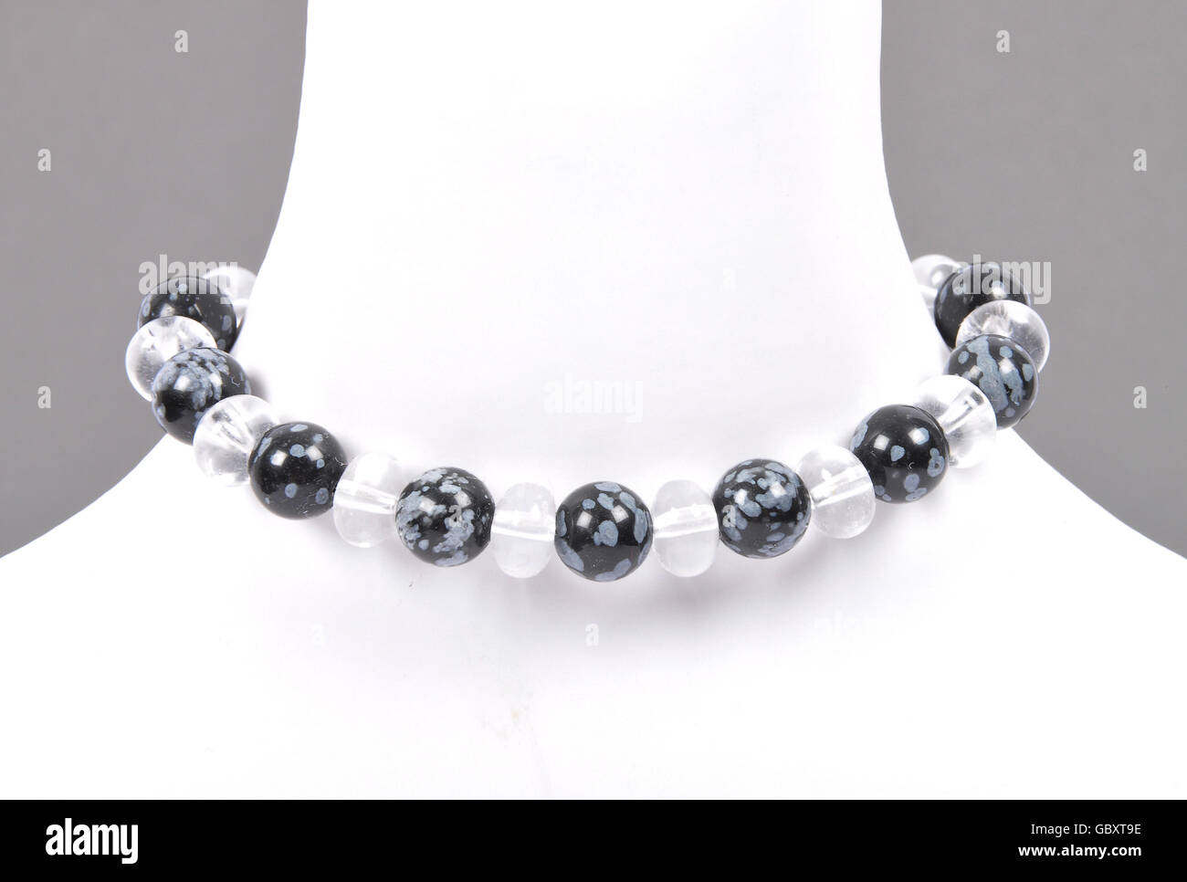 Rock crystal and snowflake obsidian chain on bust Stock Photo - Alamy
