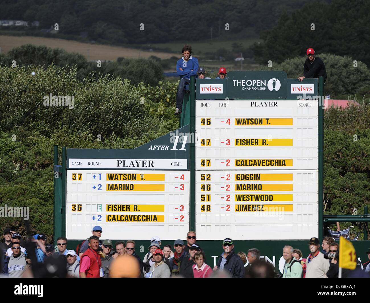Spectators watch the action from the score board during the third day ...