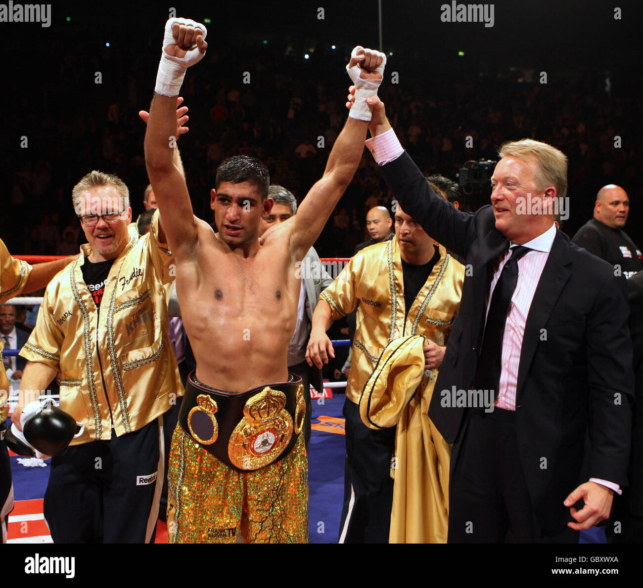 Great Britain's Amir Khan (centre) celebrates with a smiling trainer ...