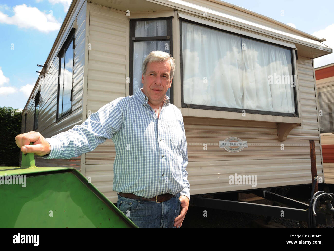 Phil Benson outside his caravan which he is still living in two years ...