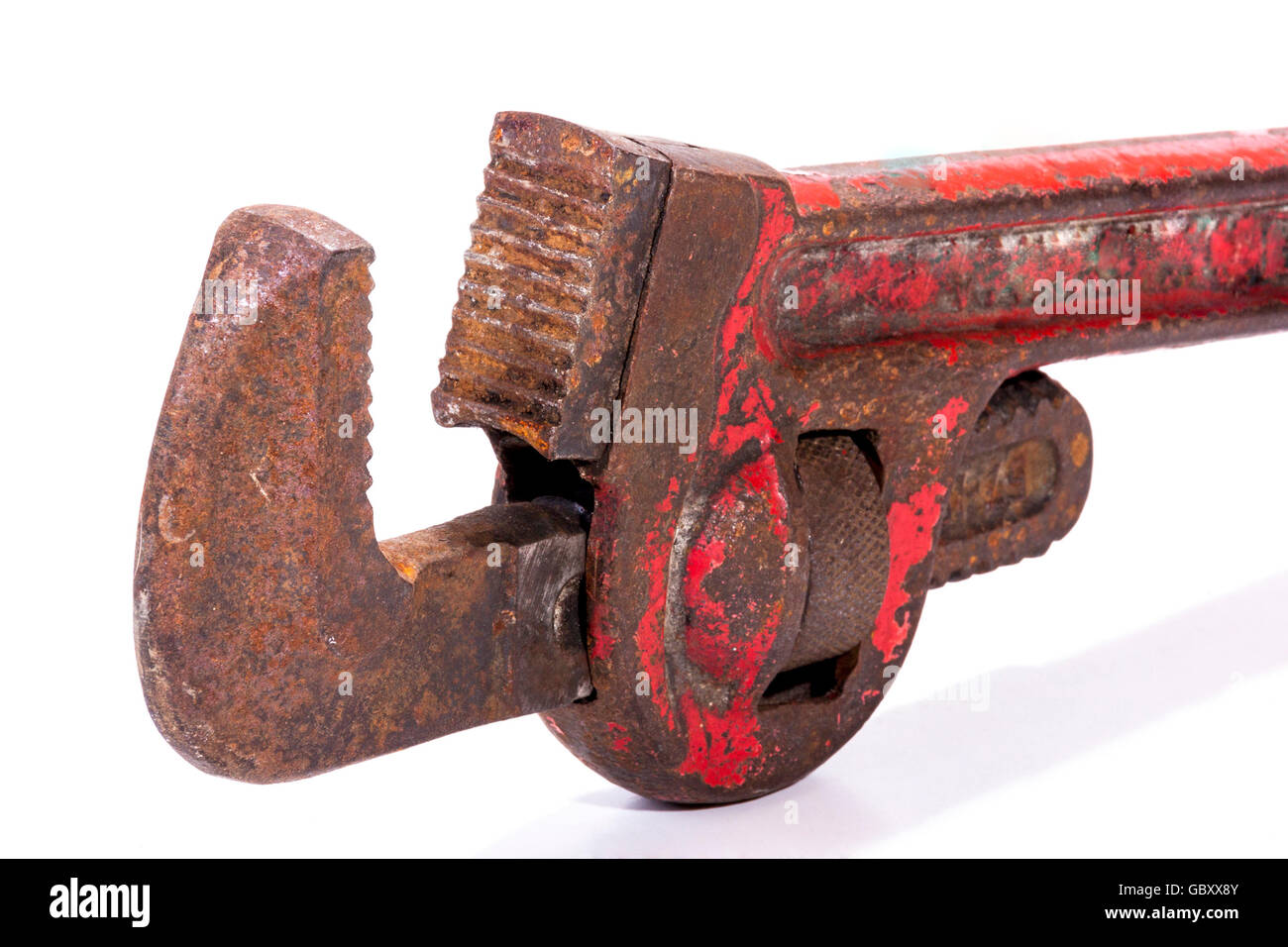 Vertical upright old neglected rusty well used red monkey wrench ...