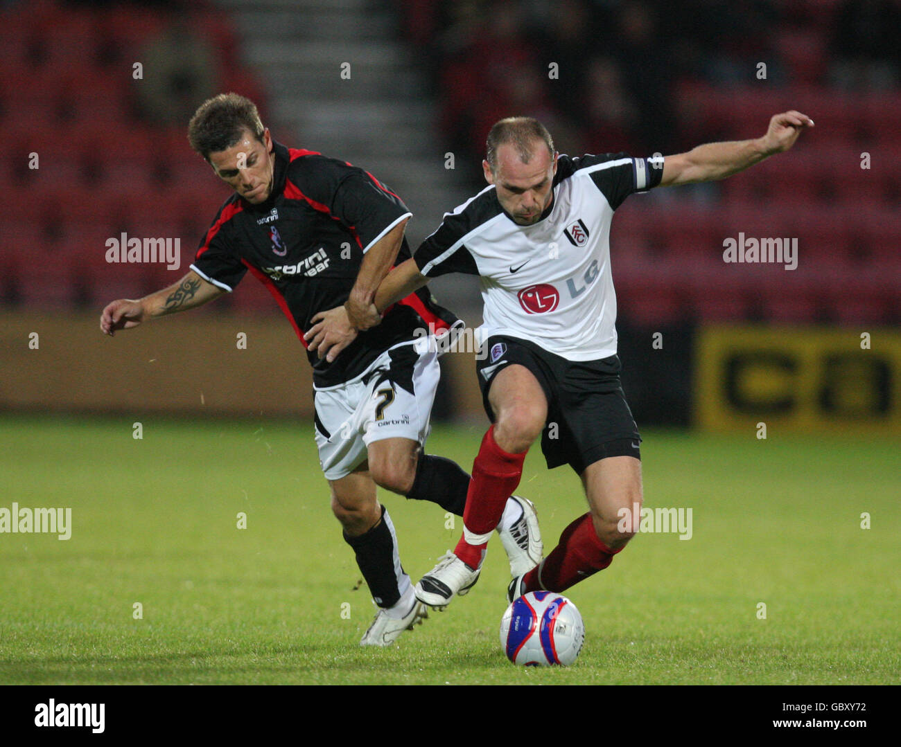 Danny murphy of fulham holds off a bournemouth player hi-res stock ...