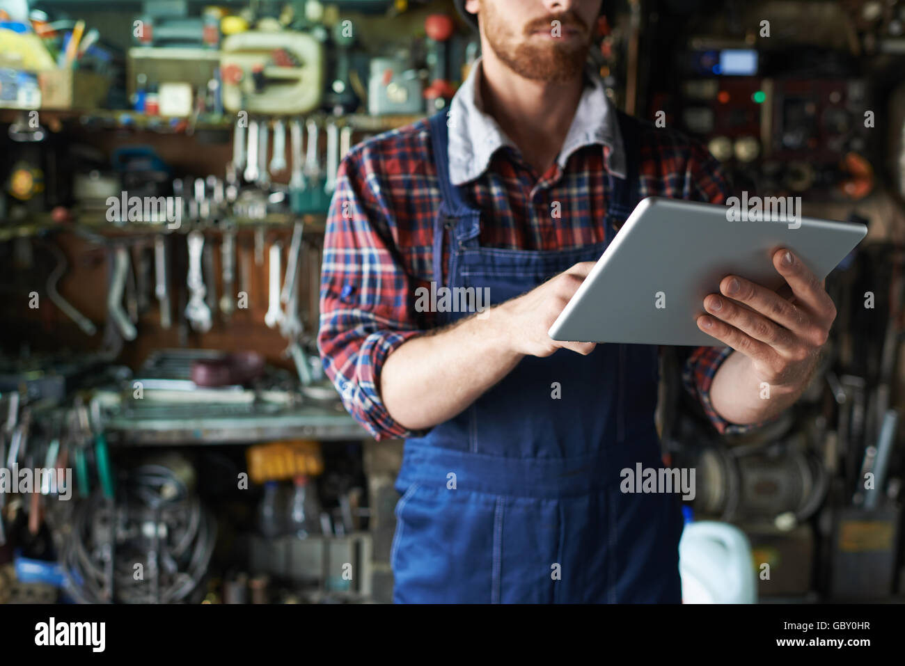 Close-up of mechanic using touchpad in work Stock Photo - Alamy