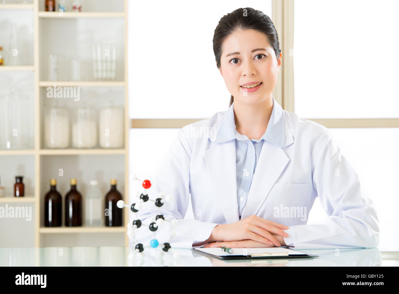 Happy female scientist with crossed arms in the laboratory with ...