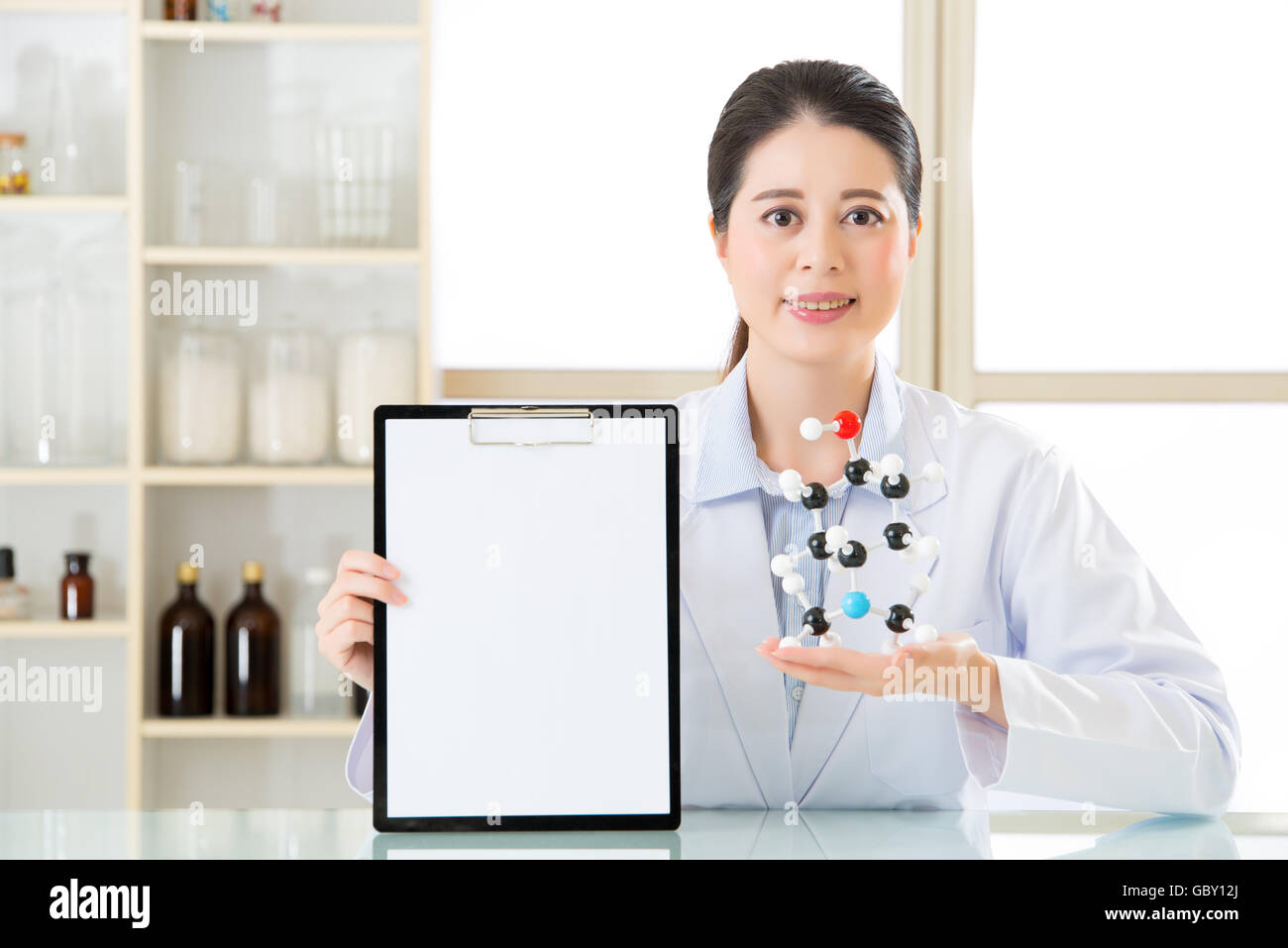 Happy smile asian female scientist holding clipboard with molecular ...