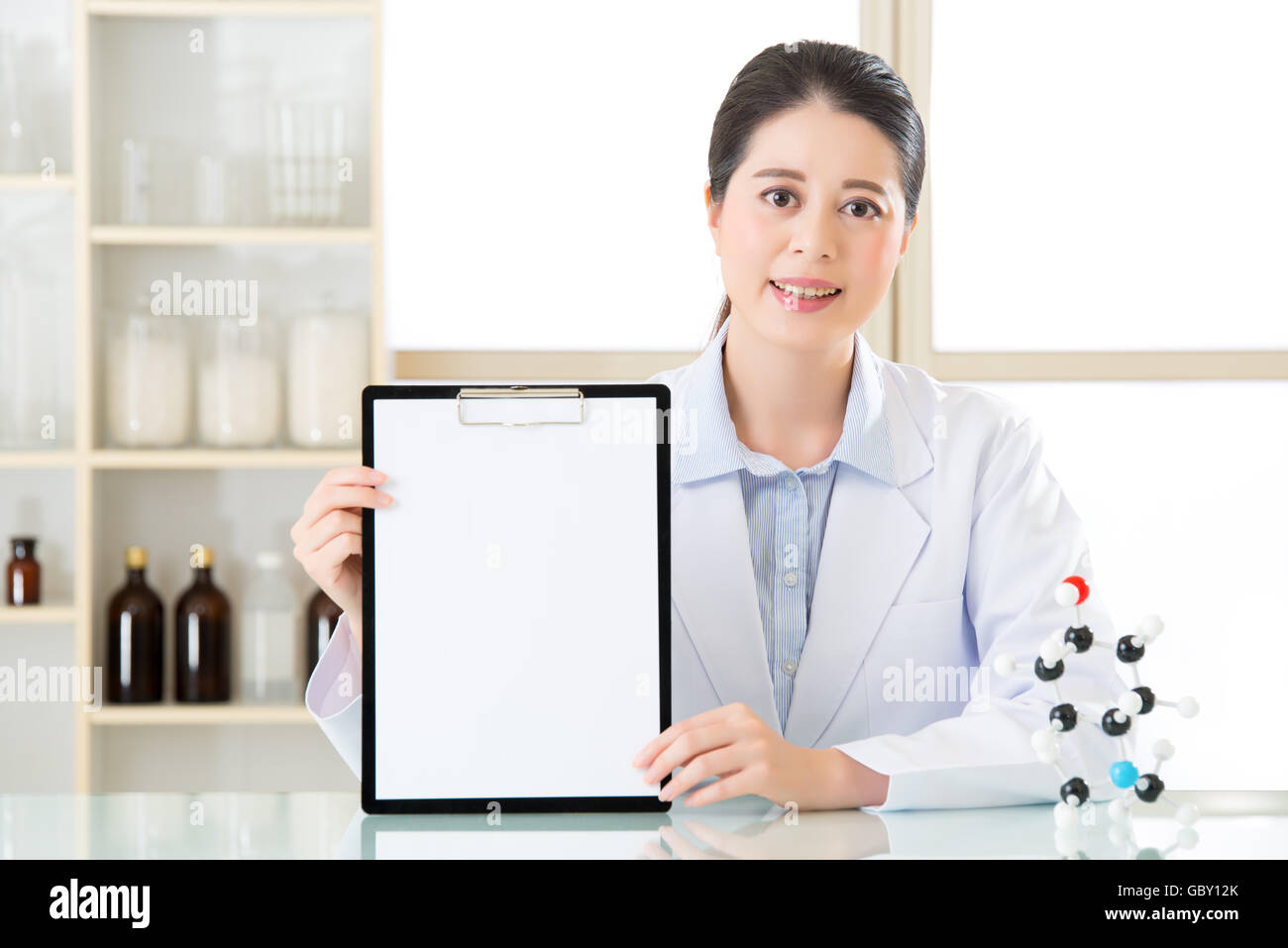 Happy smile asian female scientist holding clipboard with molecular ...