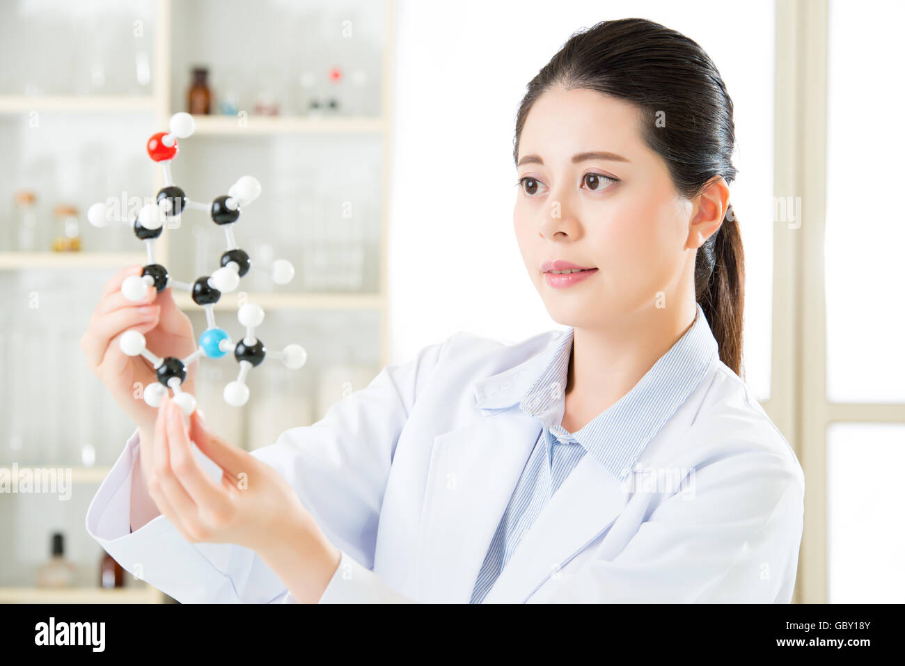 Female scientist looking at molecule model hi-res stock photography and ...