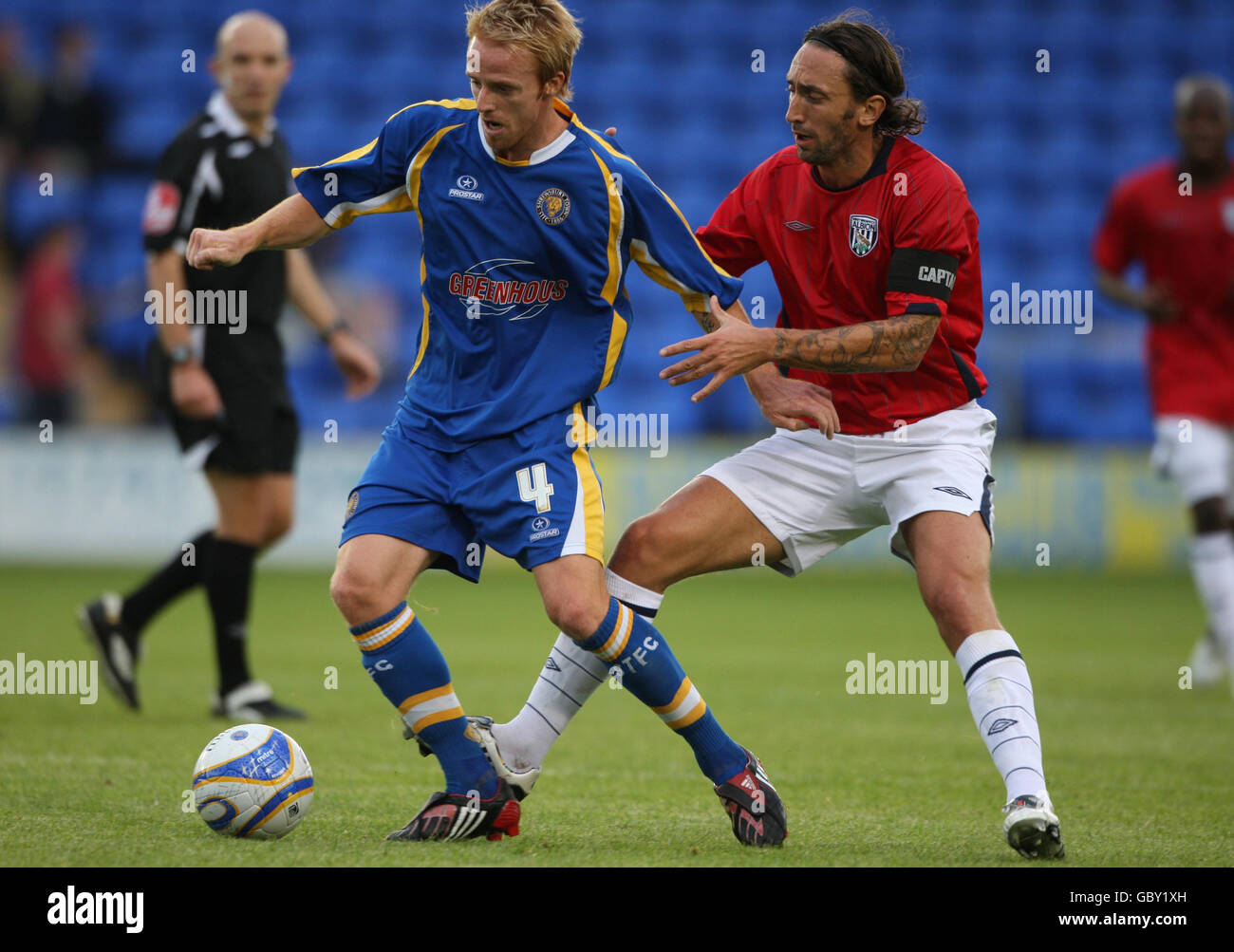 Shrewsbury Town's Craig Disley holds off West Bromwich Albion's ...