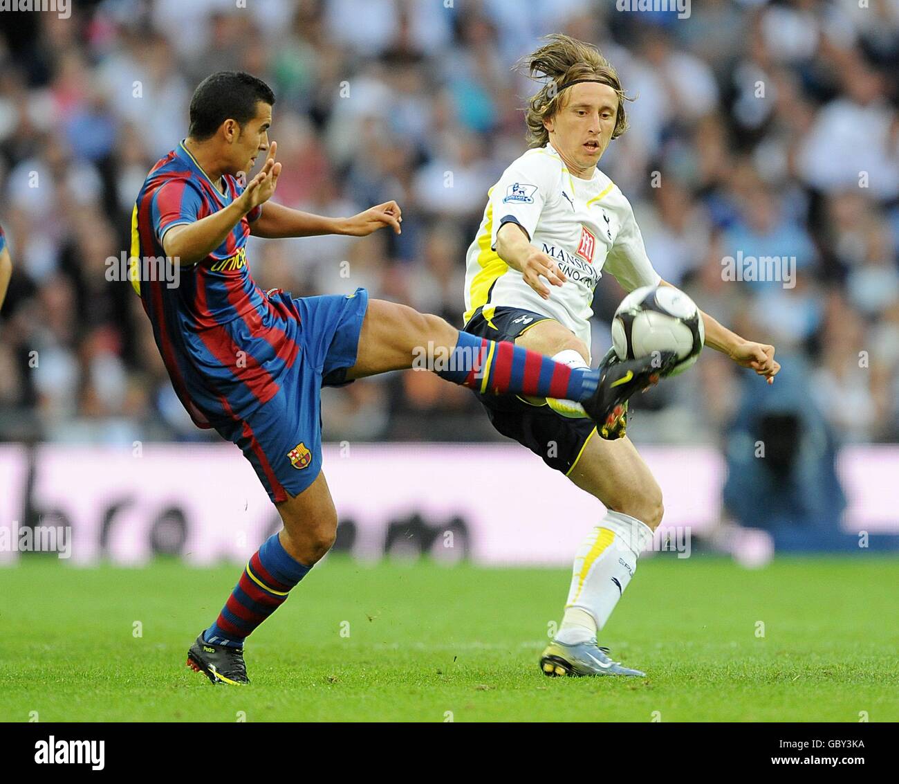 Tottenham Hotspur's Luka Modric and Barcelona's Pedro Rodriguez battle ...