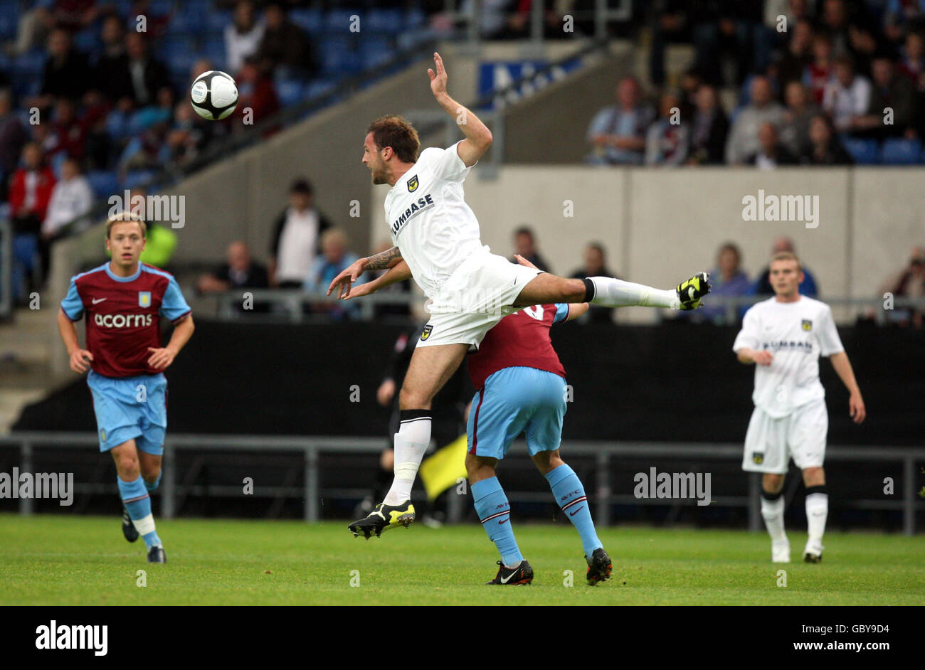 Oxford United's Luke Foster (centre) rises highest to win a high ball ...