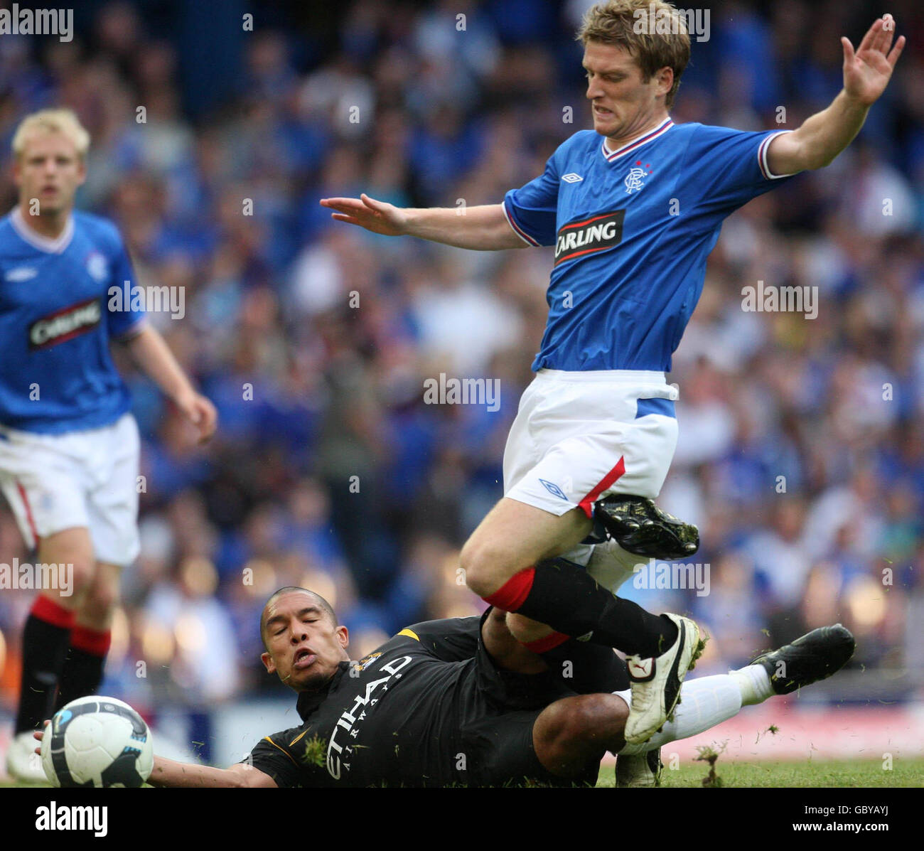Rangers' Steven Davis and Manchester City's Nigel De Jong (floor ...