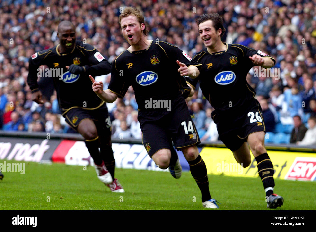 Wigan Athletic's Alan Mahon (c) is followed by his teammate as he ...