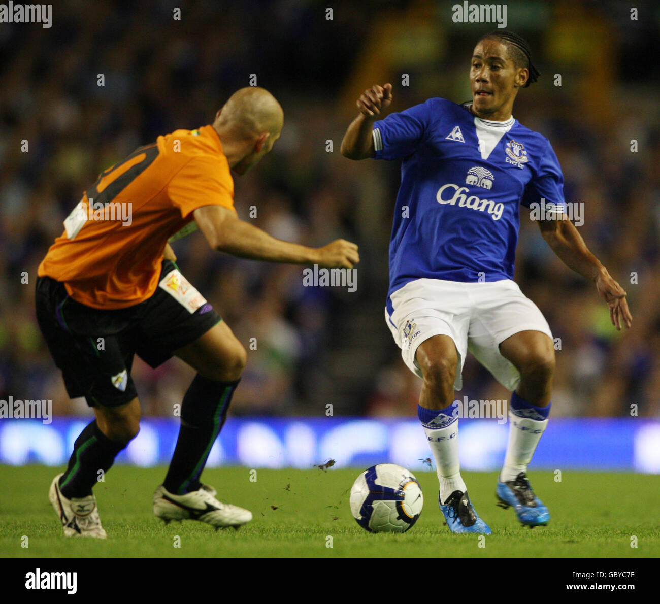 Everton's Steven Pienaar is challenged Malaga's Manolo Gaspar during ...