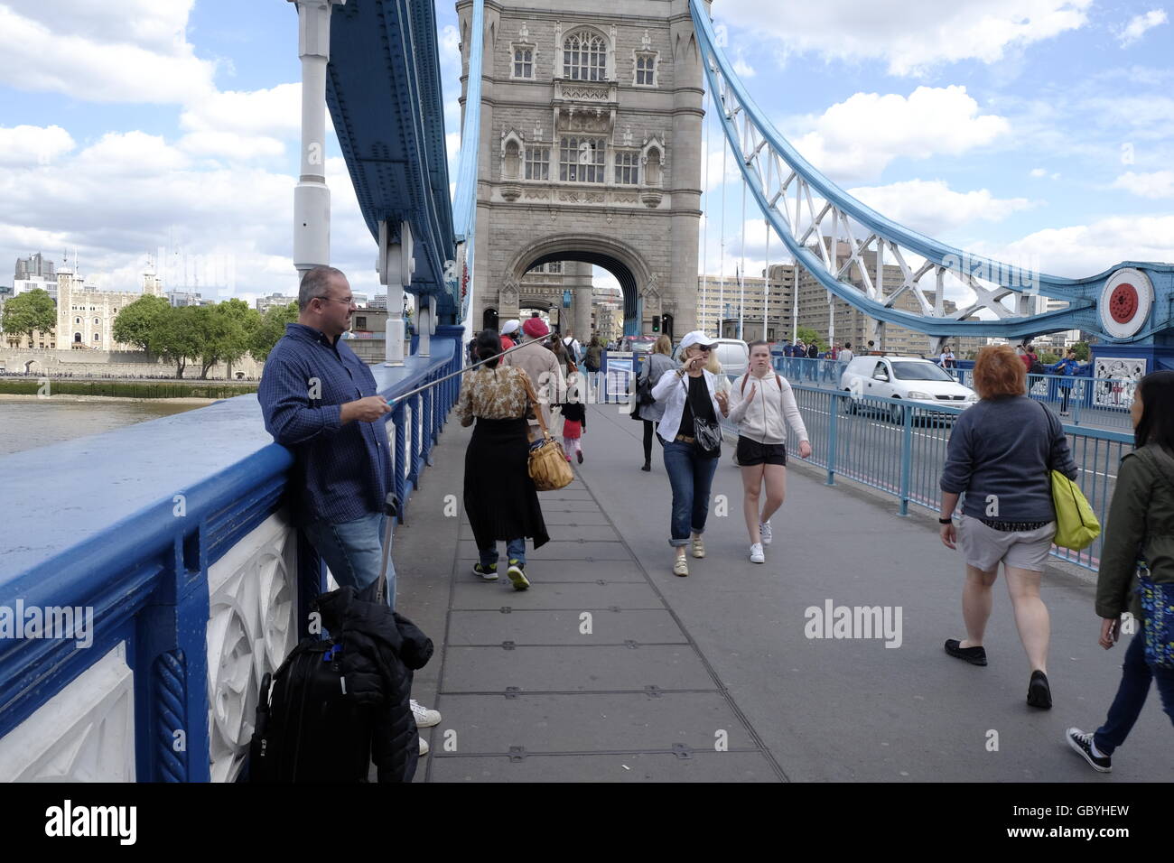 Tourist walk along the walkway on Tower Bridge a London landmark in the ...