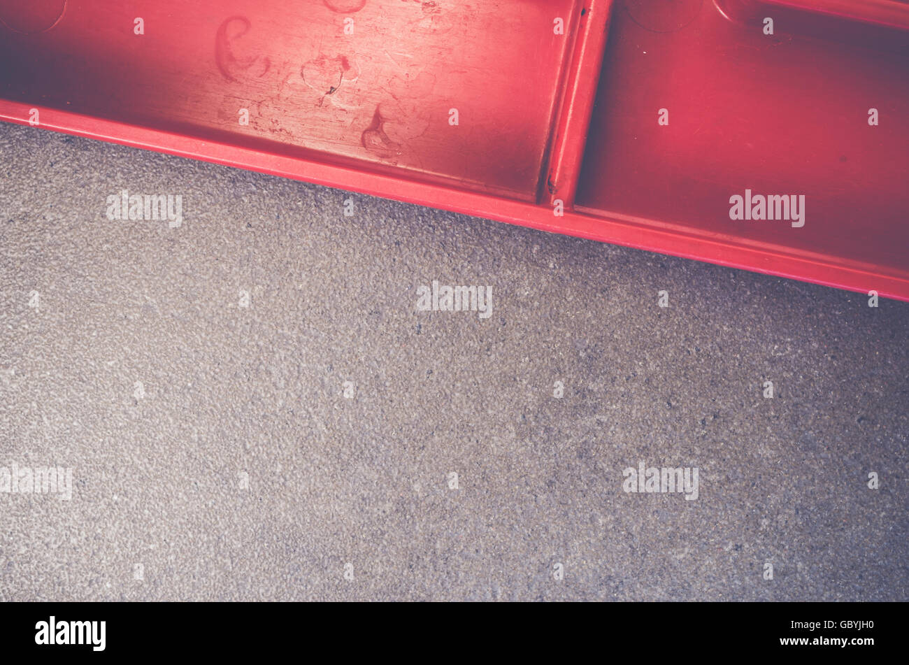 red plastic object on a stone surface Stock Photo - Alamy