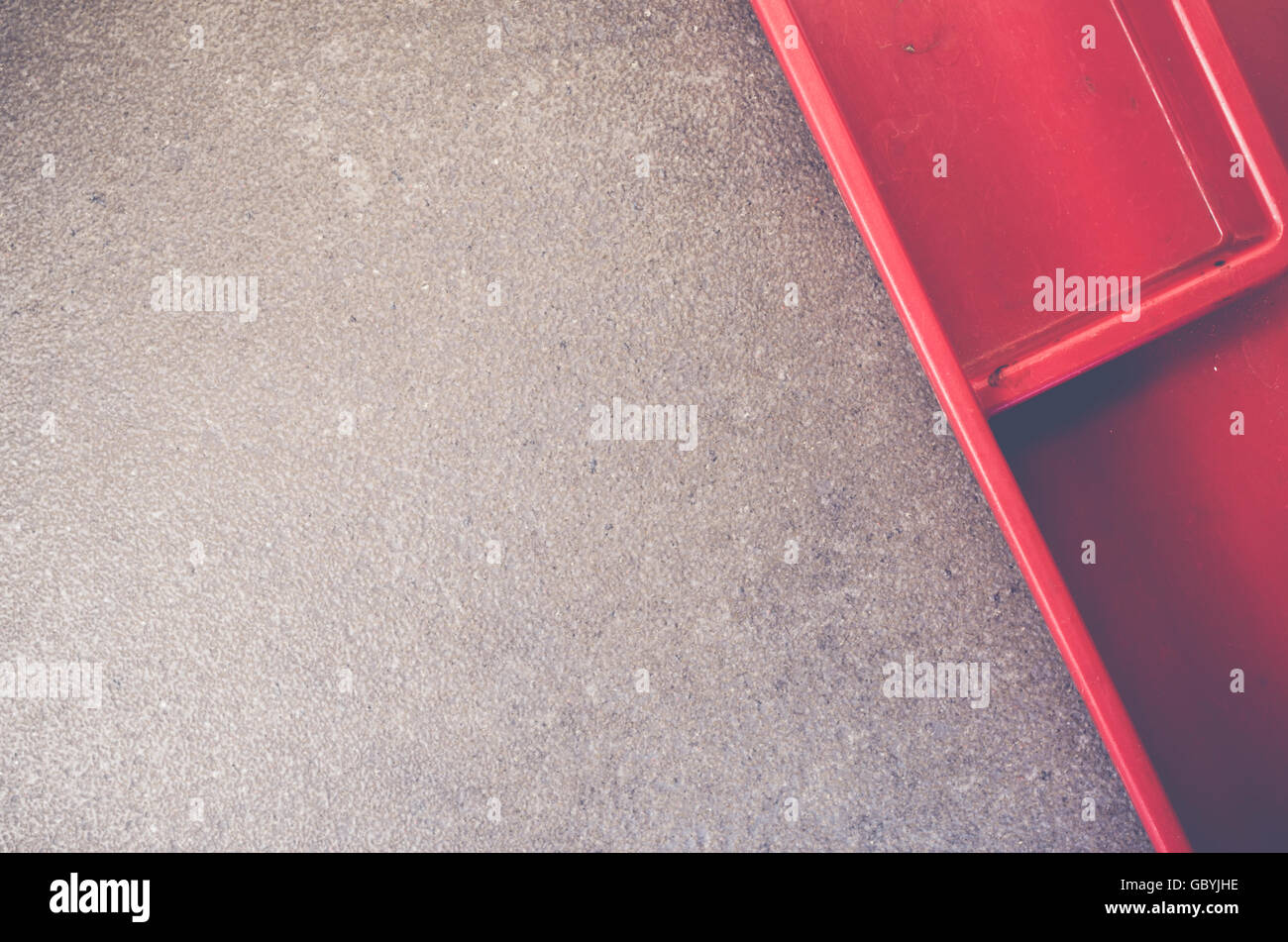 red plastic object on a stone surface Stock Photo - Alamy