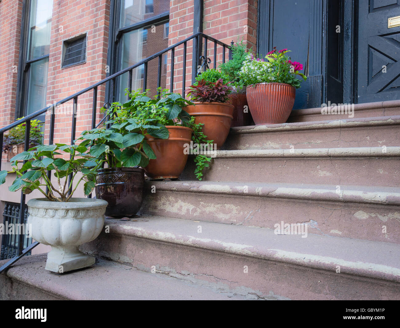 Attractive display of flower pots placed on each step of a brick ...