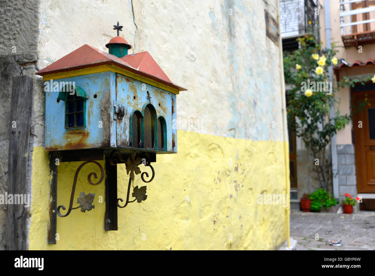 Altar with candle on Greek house wall Stock Photo - Alamy