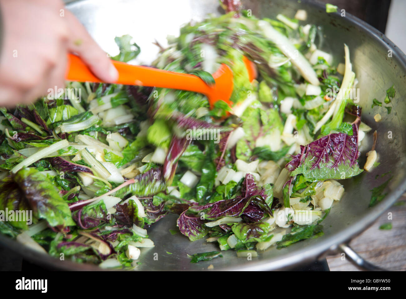 stirring in a wok dish in the garden Stock Photo - Alamy