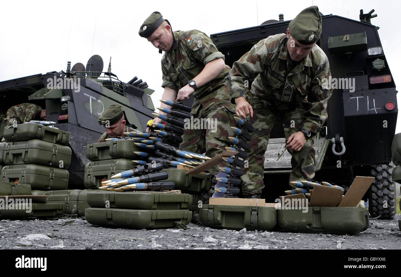 Soldiers loading 30mm shells into a mowag medium reconnaissance vehicle ...