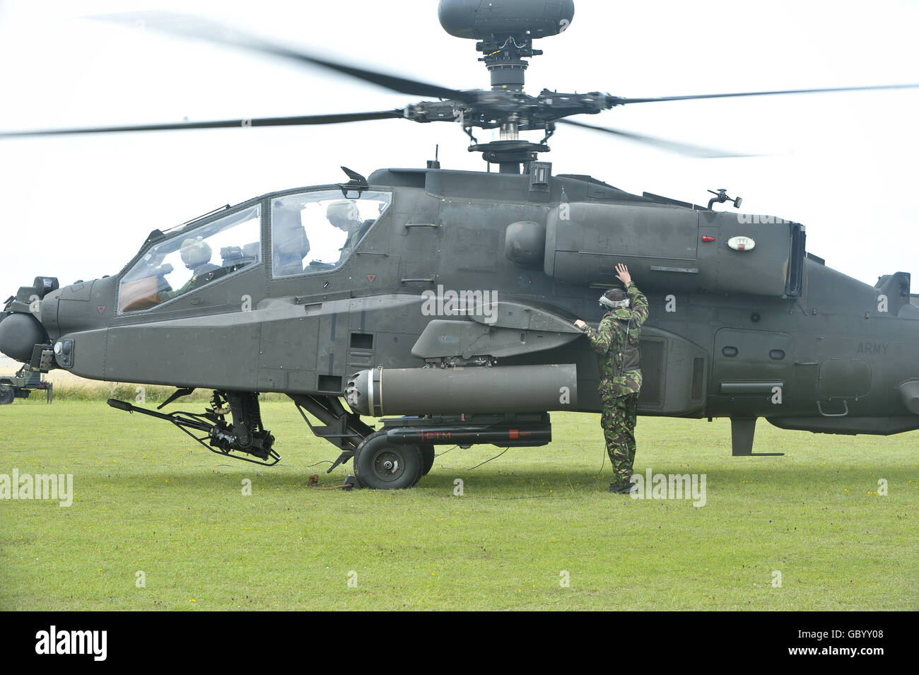A soldier makes final pre-flight checks to an Army Air Corps Apache ...
