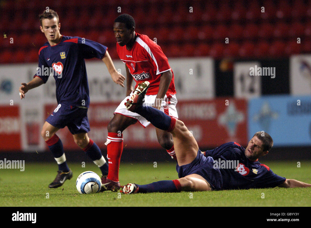 Charlton Athletic's James Walker and Portsmouth's Callum Angus (r) and Scott Harris (l) battle ...